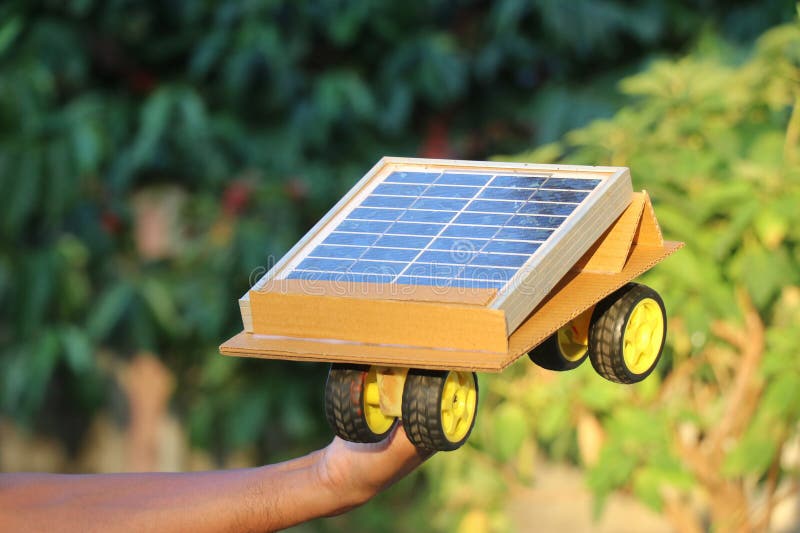 Sun or Solar Powered Car Held in the Hand. Solar Panel Converts the ...