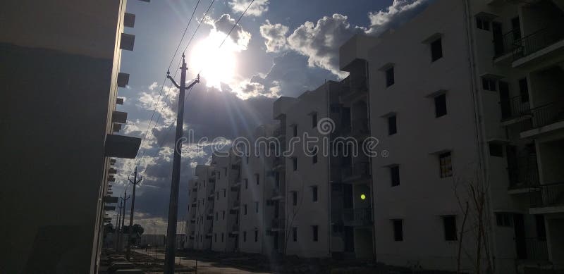 Sun is Sparkling through Clouds Over a Construction Site. Stock Image ...