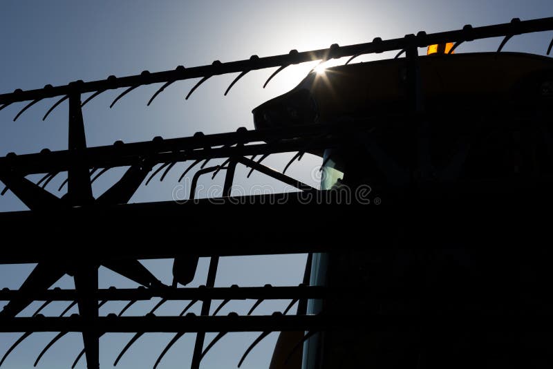 The Sun at Sunset Against the Background of the Header and the Cab of ...