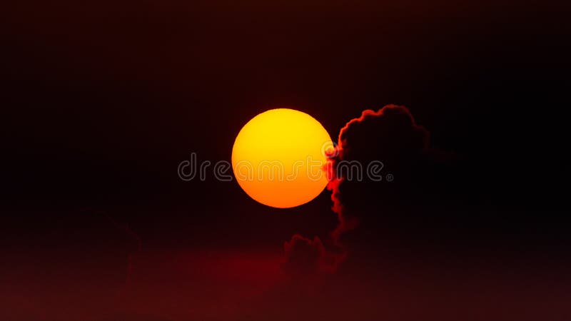 Sun at Sunset Against Red Sky with Back Lit Cloud Stock Photo - Image ...