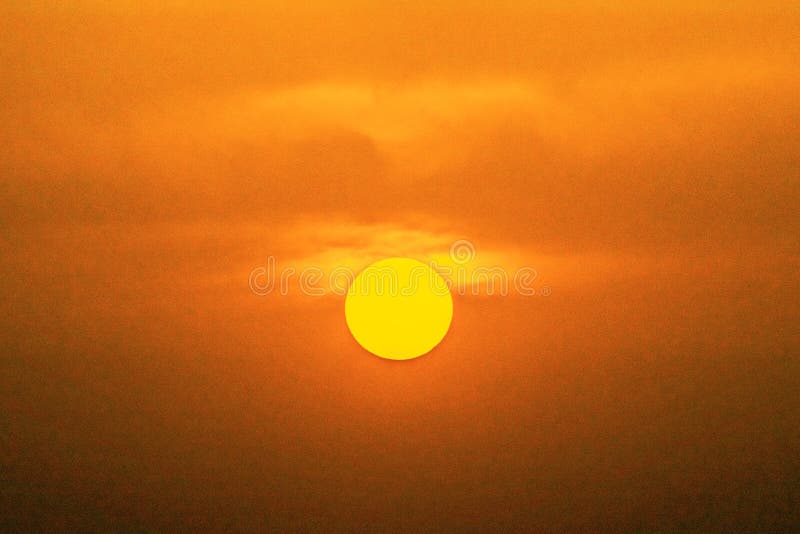 Sun during Sunset with Reddish Glow in Clouds Stock Image - Image of ...