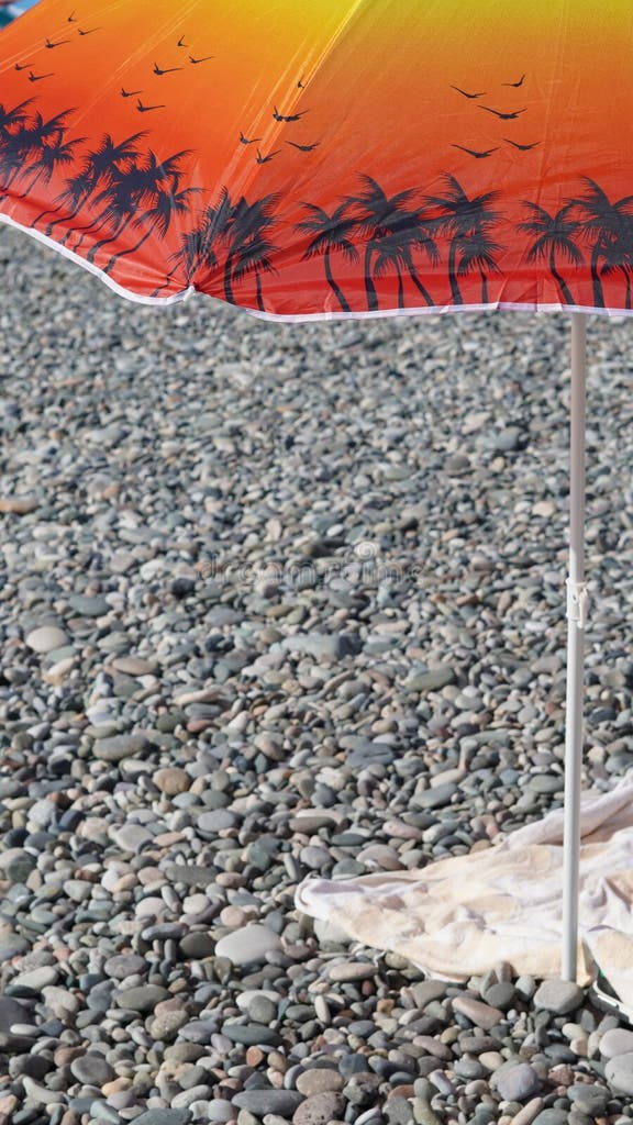 Sun Umbrella on the Pebble Beach. Stock Photo - Image of getaway, summer: 322251412