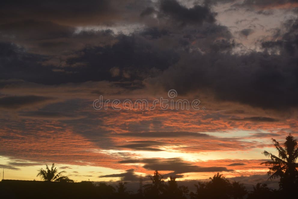 The Sun Was Setting with Light Shining through the Gray Clouds ...