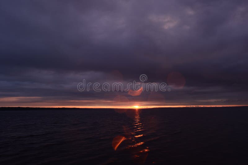 Sunbeam in the Sky on the Horizon Above Lake Water Surface from Under ...