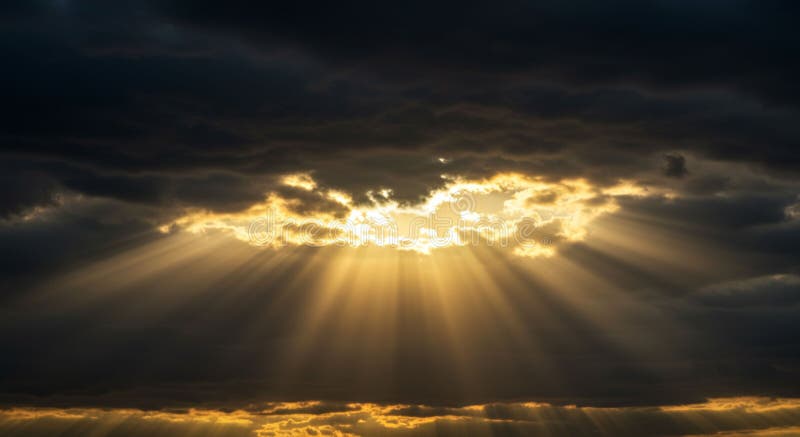 Sunbeams Burst through a Break in Thick, Dark Clouds, Creating a ...