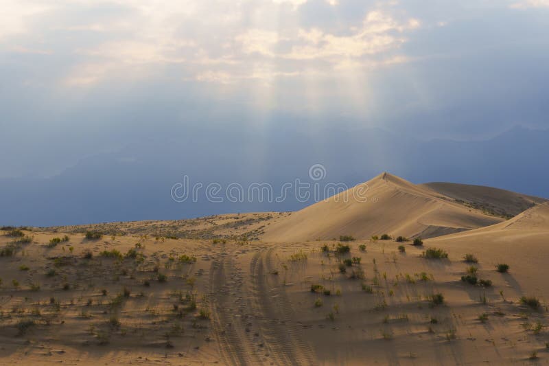 Sunbeams Over Desert Dunes with Tire Tracks Stock Image - Image of ...