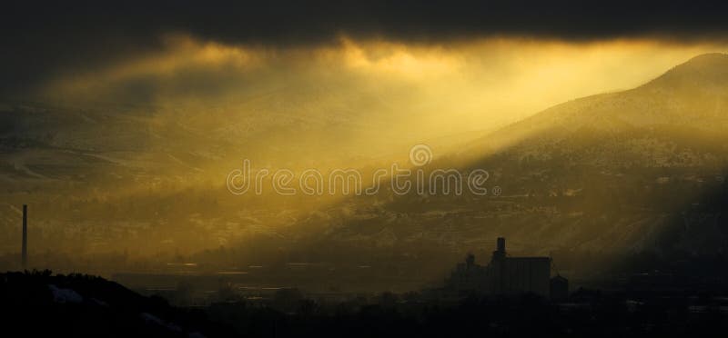 Sunbeams Sunlight Streaming Down on Town with Mountains Stock Image ...