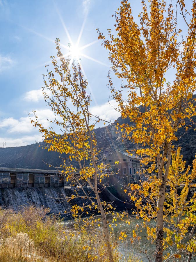 Sunburst through Autumn Trees with Boise River Dam Stock Image - Image ...