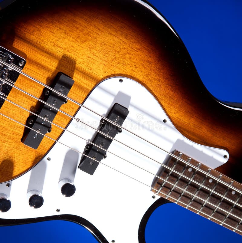 Sunburst Bass Guitar Isolated on Red Stock Photo - Image of vertical ...
