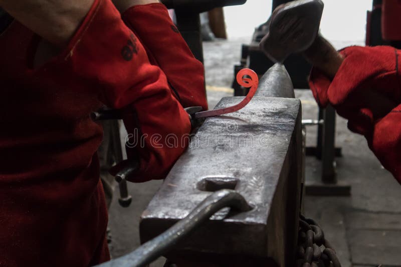 Blacksmiths Forge with Two People Working on Metal Using Hammer and ...