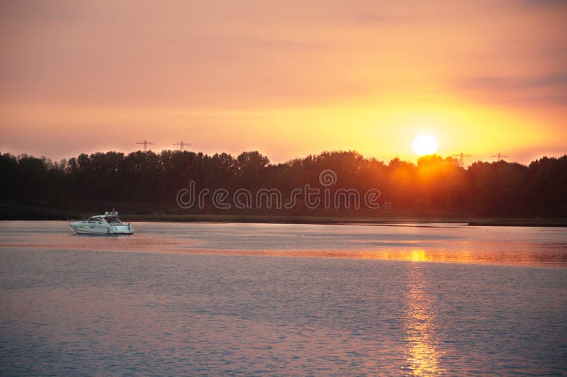Sundown on the River. Yacht in Rays of the Setting Sun Stock Image ...