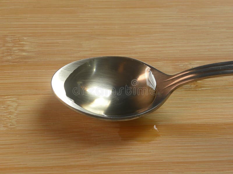 Sunflower oil on spoon stock photo. Image of food, helianthus - 166604144