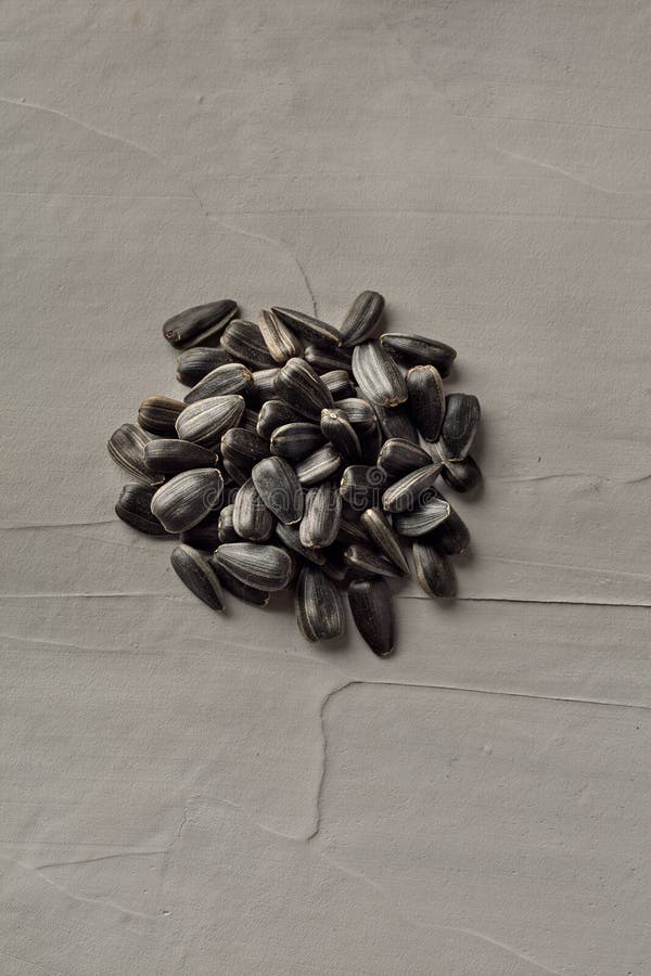 Sunflower Seeds on a Gray Table. Lie in a Small Handful Stock Photo ...