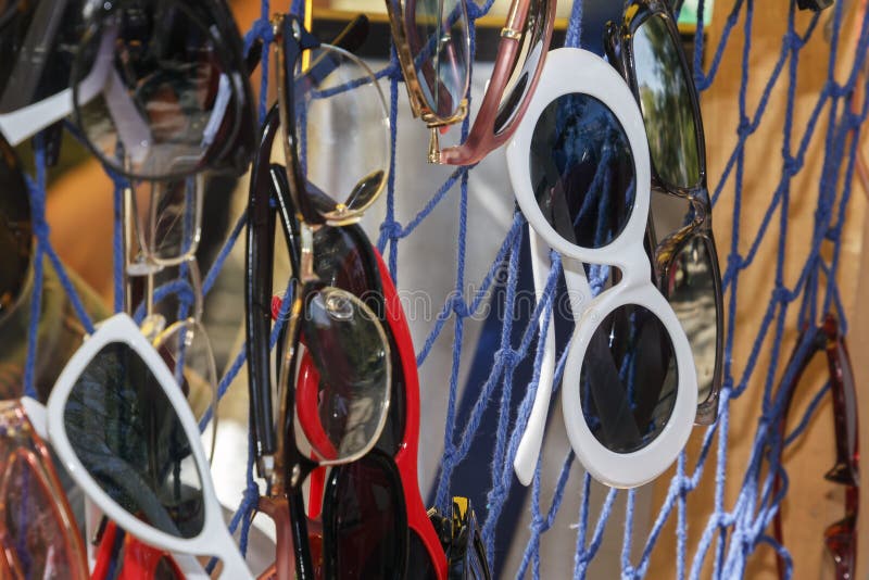 Sunglasses of Different Types are Hung on Colored Threads for Sale on a ...