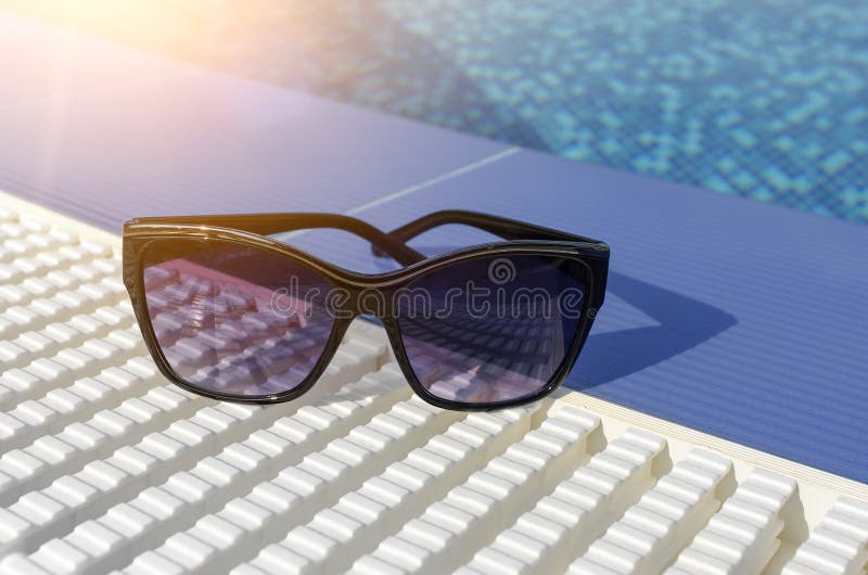 Sunglasses on the Edge of the Pool. Stock Image - Image of poolside ...