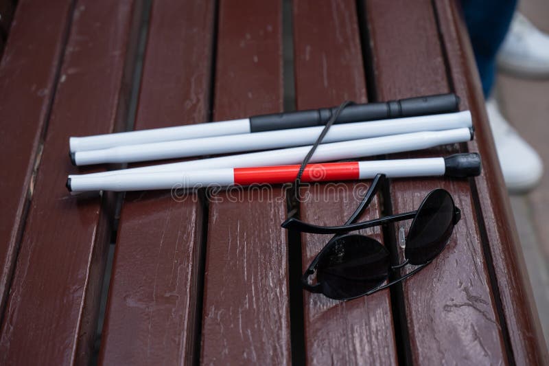 Sunglasses and a Folding Cane for the Blind on a Bench. Stock Photo ...