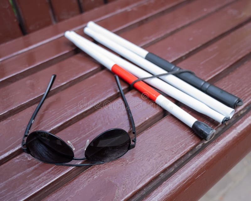 Sunglasses and a Folding Cane for the Blind on a Bench. Stock Photo ...