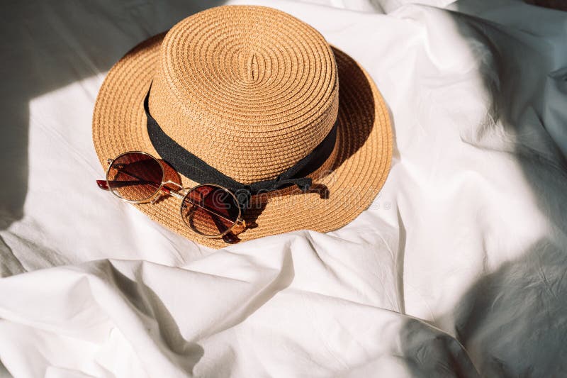 Sunglasses and Hat on White Bed Under the Sunbeams Stock Photo - Image ...