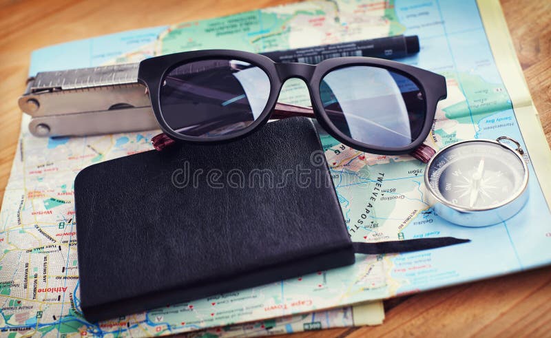 Sunglasses, Map and Notebook with Compass on Table for Itinerary ...