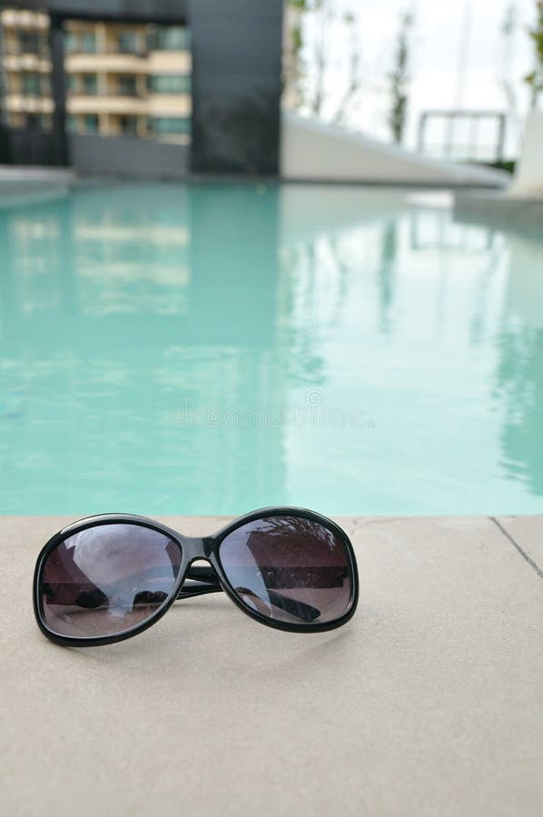 Sunglasses by the Outdoor Swimming Pool Stock Photo - Image of ...
