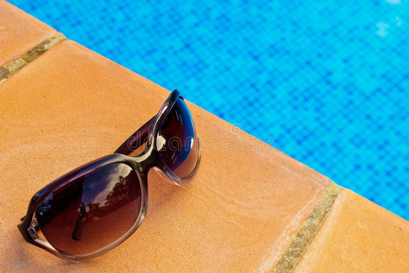 Sunglasses by pool stock photo. Image of sunny, bright - 22374800