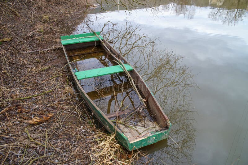 Sunken River Boat with Reflection of Tree Branches Stock Photo - Image ...