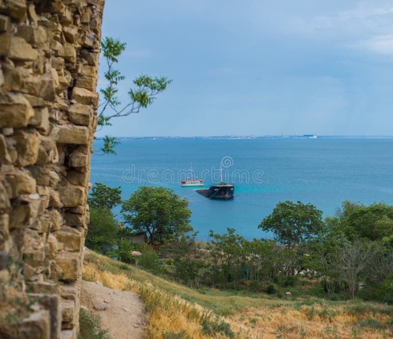 Sunken Ship Off the Shore on Which There is a Stone Fortification Wall ...