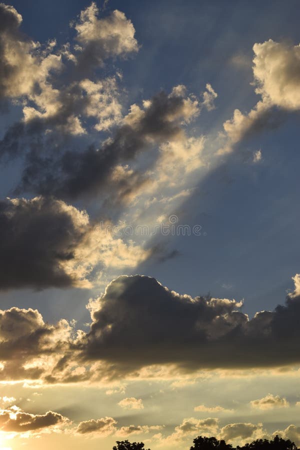 Sunlight beaming in clouds stock photo. Image of silhouette - 85875872