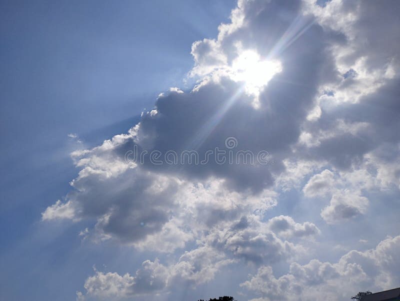 Sunlight Blocked by White Clouds on a Bright Day Stock Photo - Image of ...