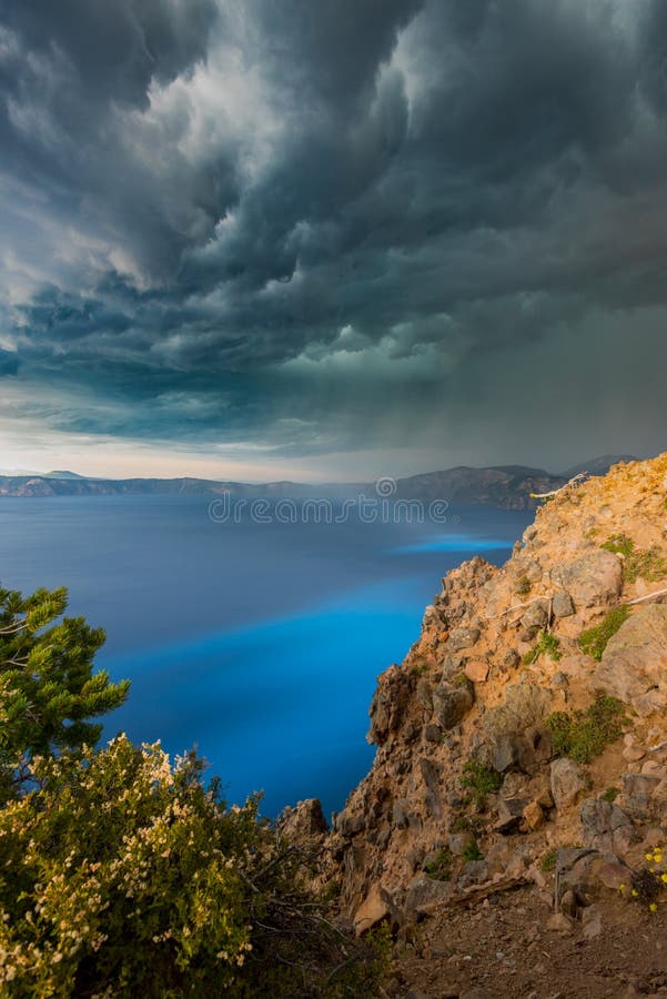 Sunlight Burst through Storm Clouds Over Crater Lake Stock Photo ...