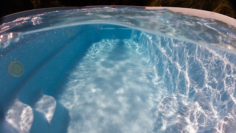 Sunlight Dances on the Steps and Walls of a Clear Backyard Pool ...