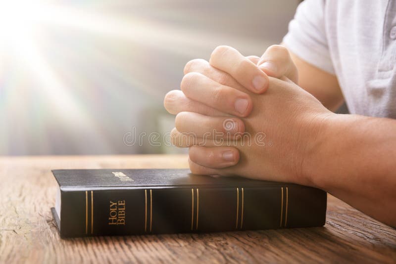 Man`s Praying Hand on Bible Stock Photo - Image of finger, bible: 149378688