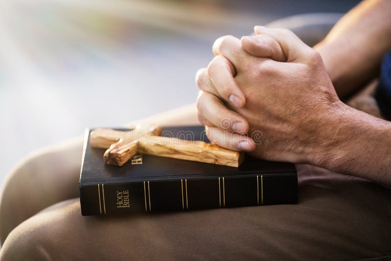 Man`s Praying Hand on Bible Stock Image - Image of book, capital: 210747903