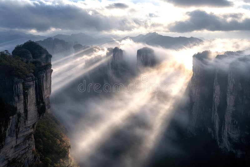 Sunlight Piercing through Clouds Over Majestic Mountain Peaks Stock ...