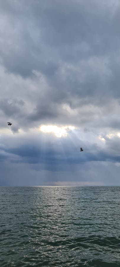 Sunlight on the Sea through the Filter of Rain Clouds Stock Photo ...
