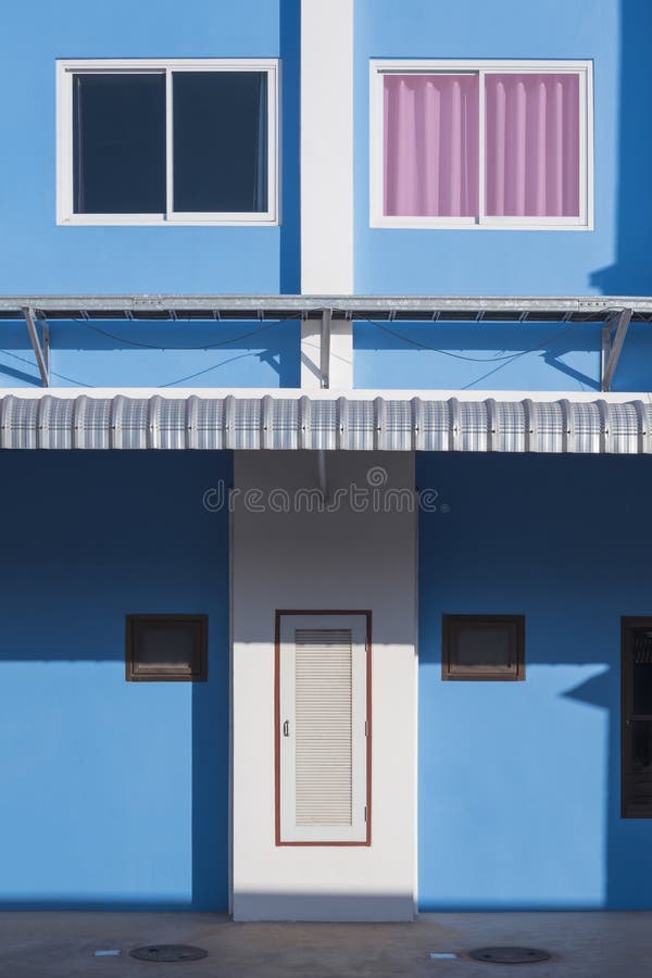 Glass Windows with Awning of Blue Building in Vertical Frame Stock ...