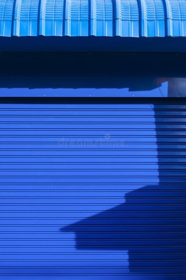 Sunlight and Shadow on Surface of Automatic Blue Roller Shutter Door ...