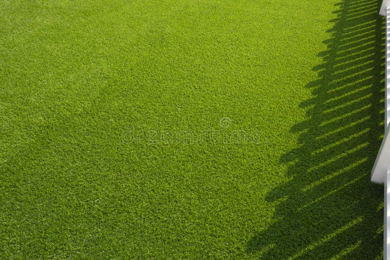 White Wooden Fence on Surface of Green Artificial Turf in Front Yard of ...