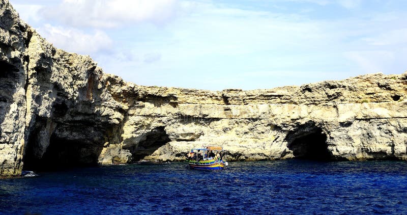 Sunlight on Smugglers Cave and Cliffs Editorial Stock Image - Image of ...