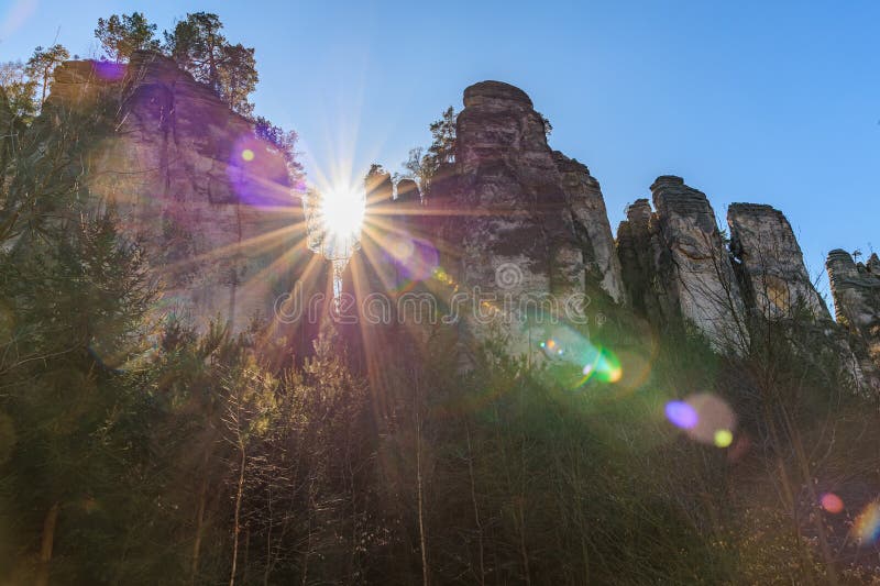 Sunlight Streaming through Rocky Cliffs and Trees in a Majestic Natural ...
