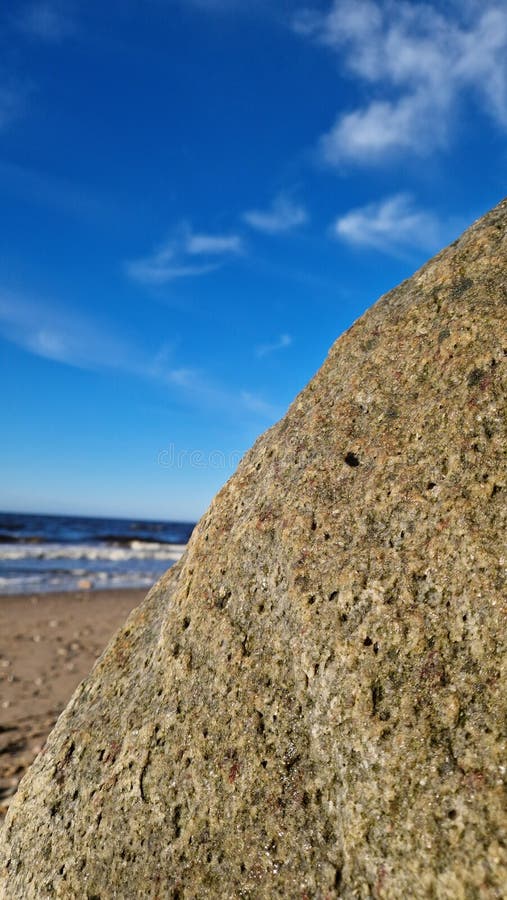 Sunlit Boulder on Beach with Blue Sky Stock Photo - Image of coastal ...