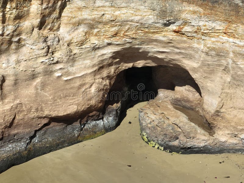 Sunlit Cave in the Cliff with a Smooth Surface, Sandy Ground Stock ...