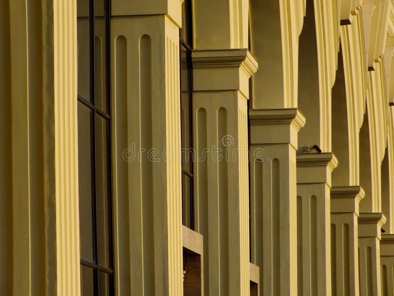 A Sunlit Colonnade with Arches Stock Photo - Image of building, arched ...