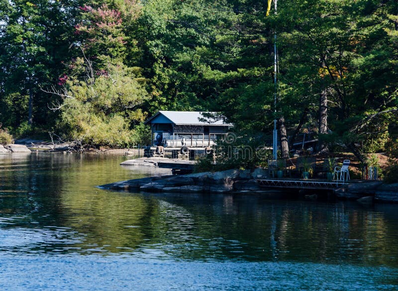 Sunlit Cottage on a River S Bay Stock Photo - Image of evergreen ...