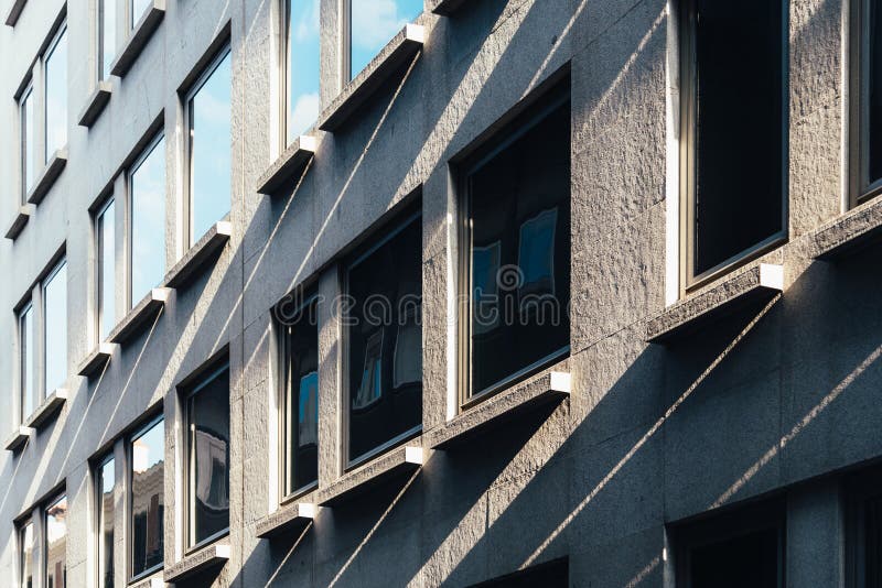 Sunlit Modern Building Facade Stock Image - Image of texture, windows ...