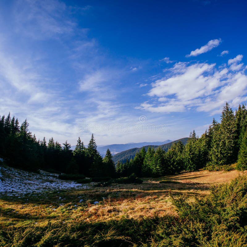 Sunlit Mountain Slope and Distant Valley at Sunrise Stock Photo - Image ...