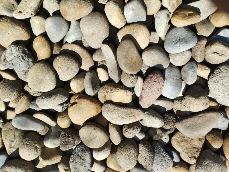 Sunlit Round Pebble Rocks, Textures are Evident, Shadows Create ...
