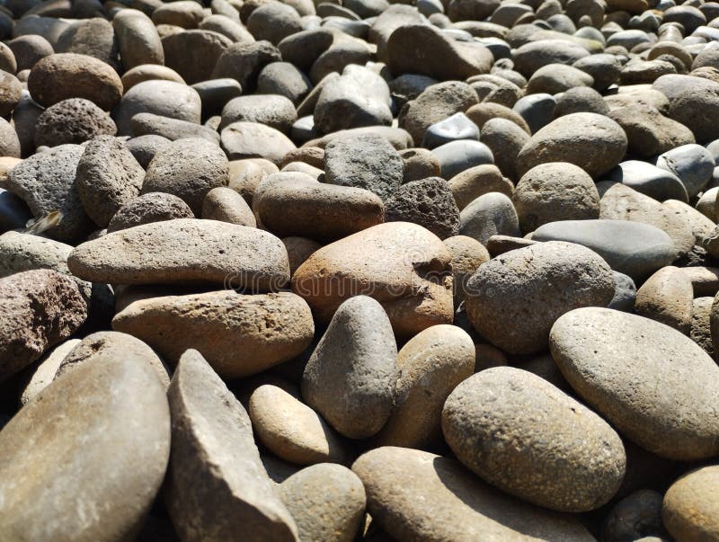 Sunlit Round Pebble Rocks, Textures are Evident, Shadows Create ...