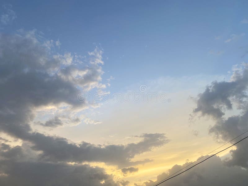 Sunlit Sky: Clouds, Sunlight Rays, and Black Cable Wire Stock Image ...