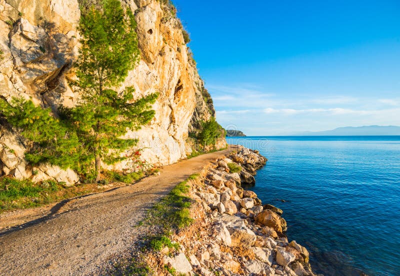 Walking Path Along the Sea Coast with Blue Water at Sunset in Greece ...